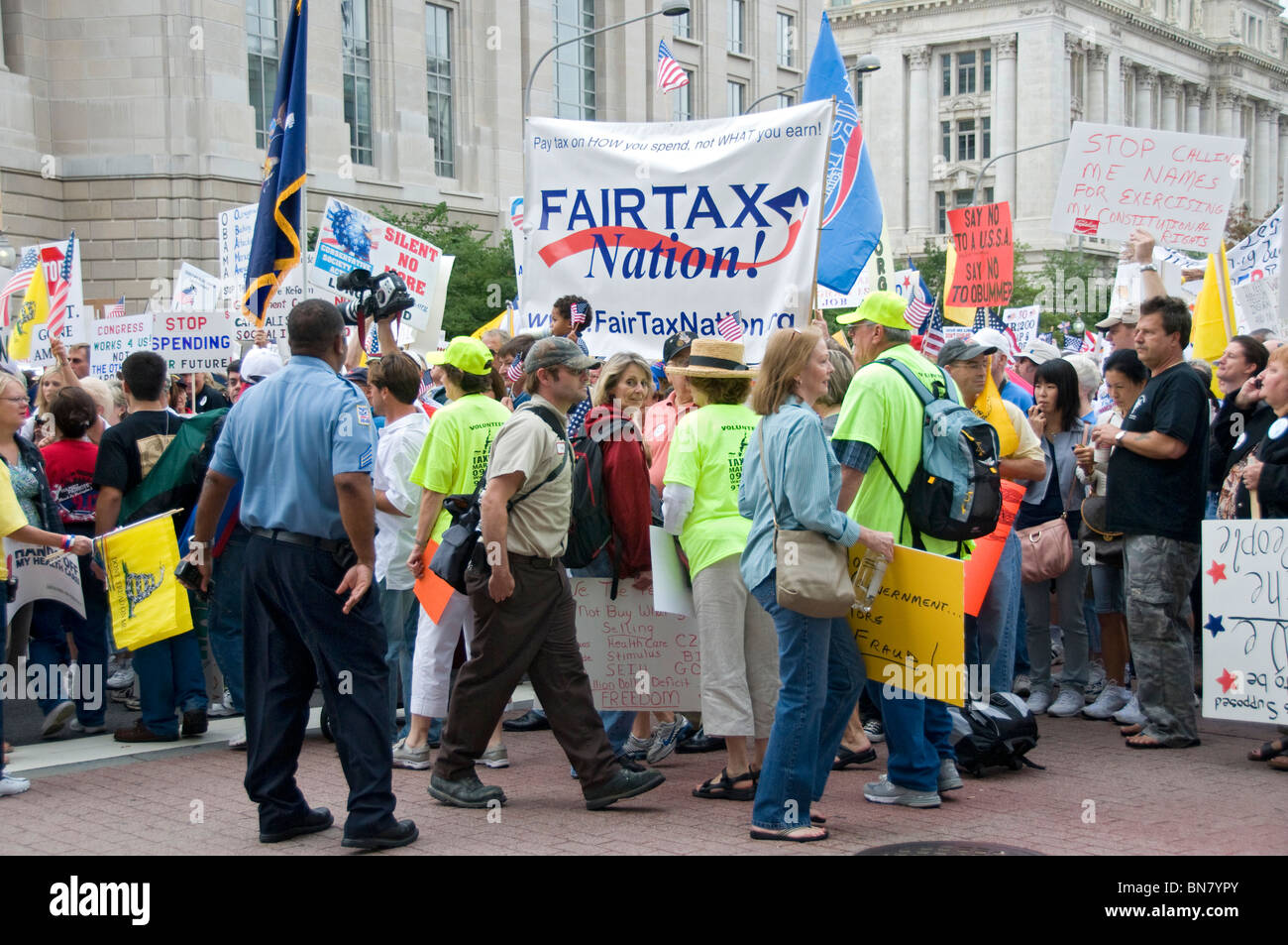 African American Male Police Officer controls crowd at protest rally ...