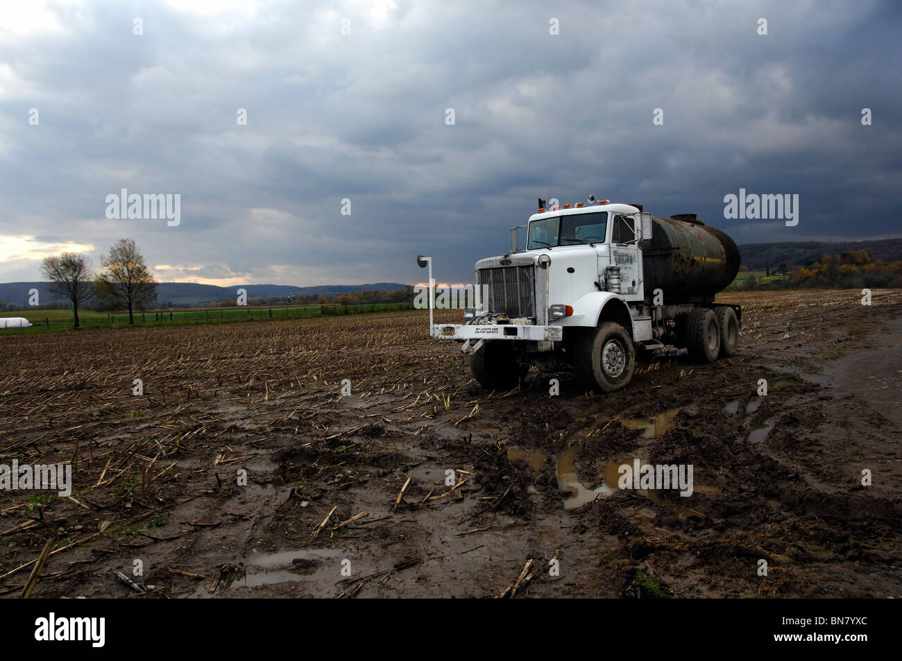 A fertilizer truck on a muddy field Stock Photo - Alamy