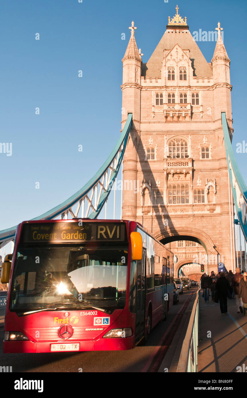 Red London bus crossing Tower Bridge, London, United Kingdom Stock ...