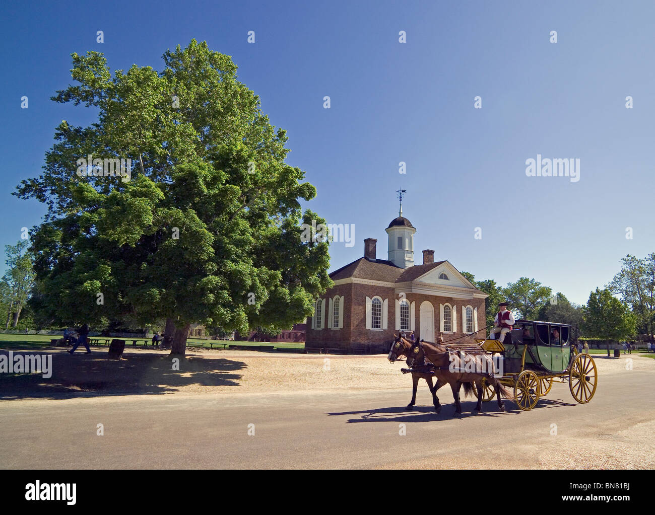 Visitors enjoy a horse-drawn carriage ride past the 1770s Courthouse on ...