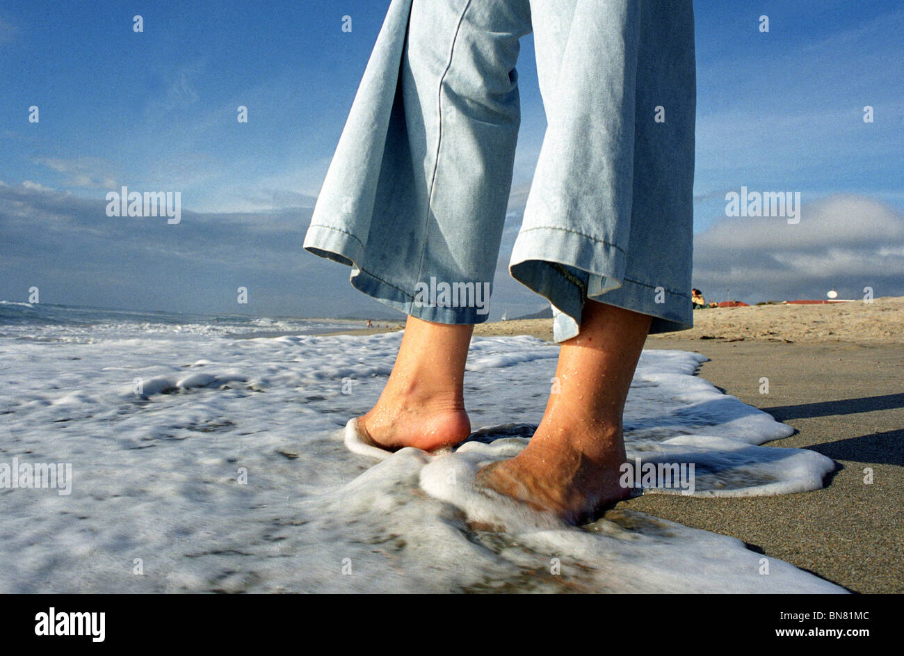 Feet and waves Stock Photo - Alamy