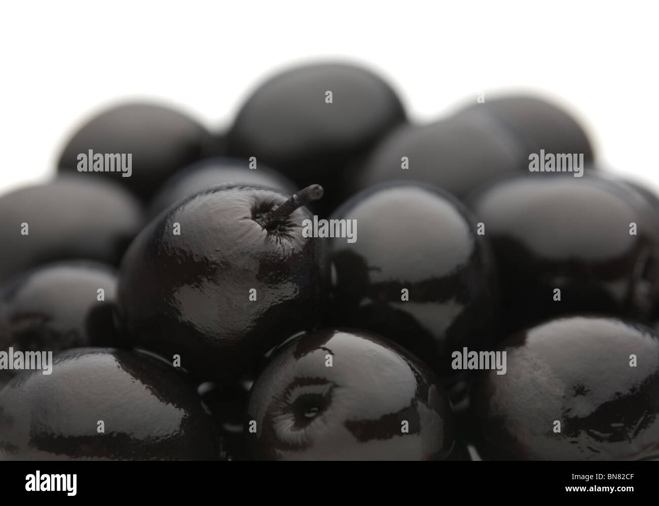 Black salted olive vegetable closeup view background Stock Photo - Alamy