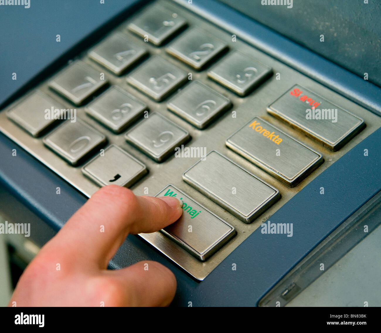 Typing a pin number into a chip and pin machine Stock Photo - Alamy