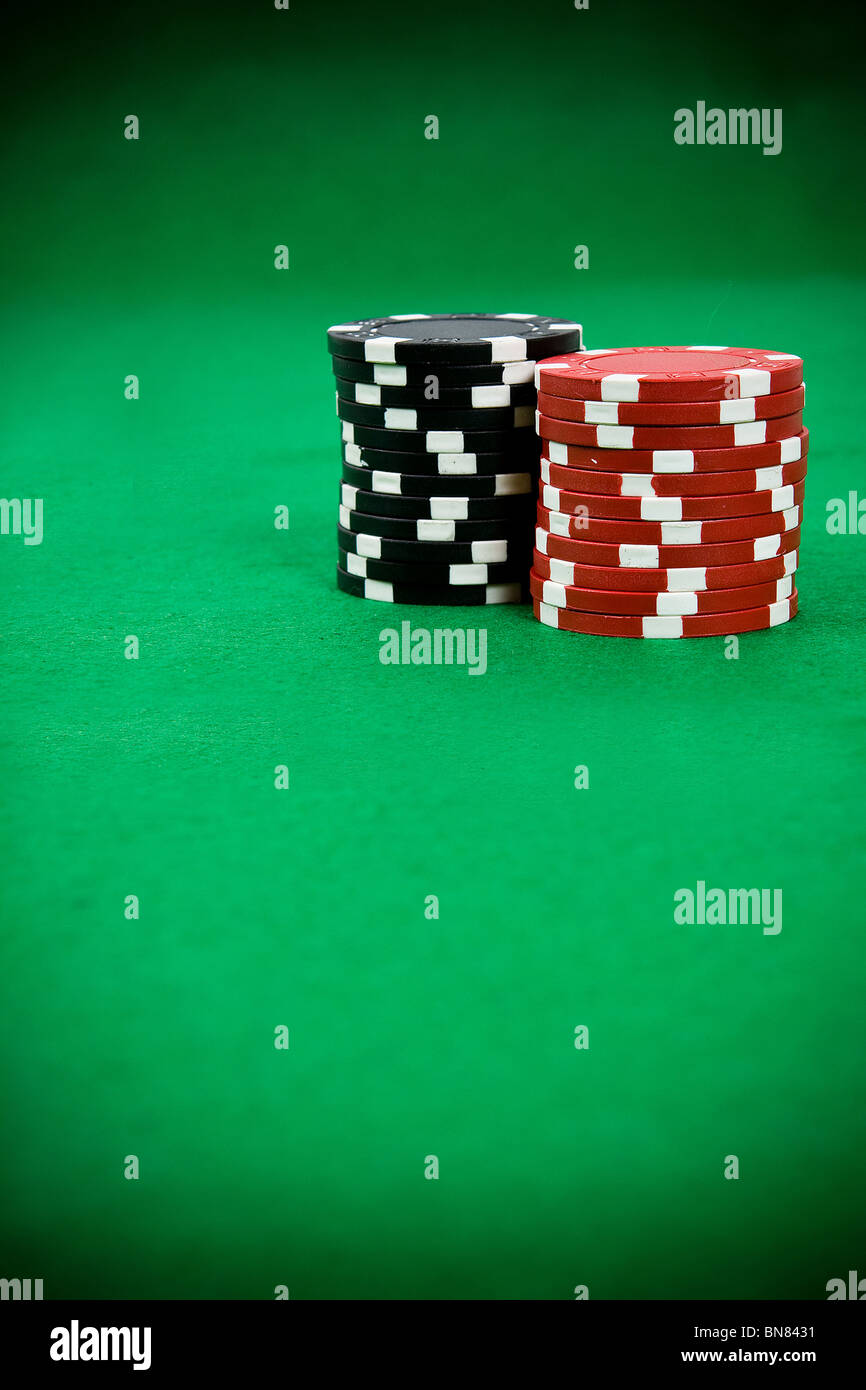 Stack of poker chips on green background Stock Photo - Alamy