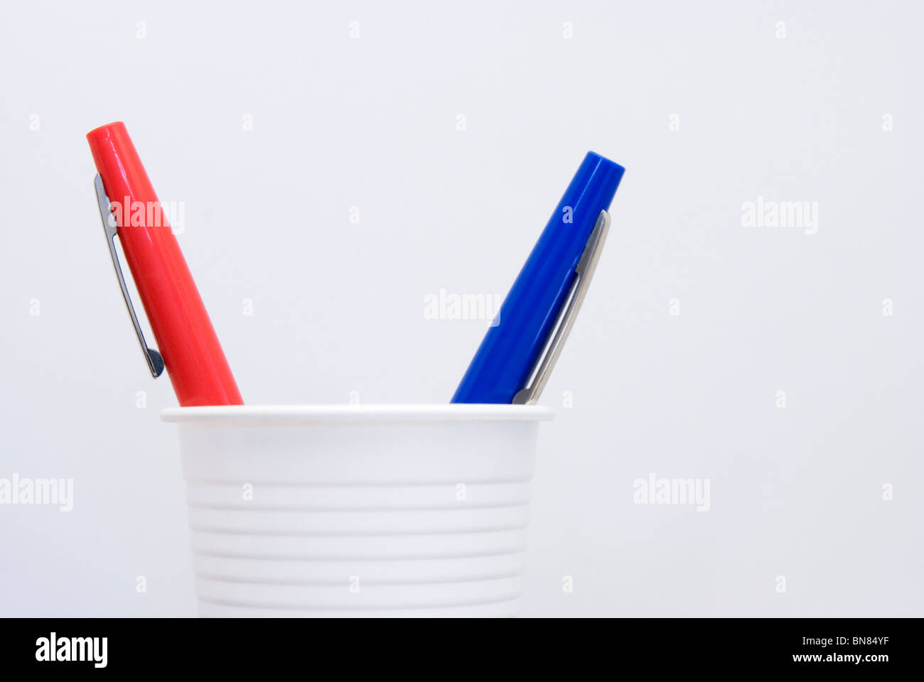 Red and Blue felt pens in White Cup Stock Photo - Alamy