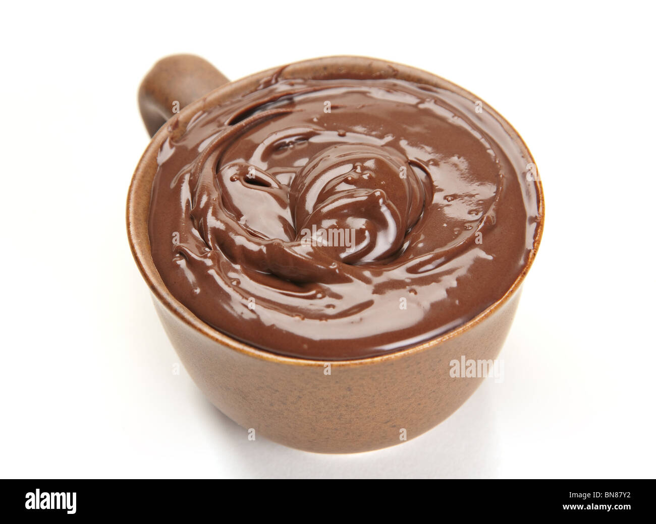 Nut cream with cacao in brown cup on white Stock Photo - Alamy