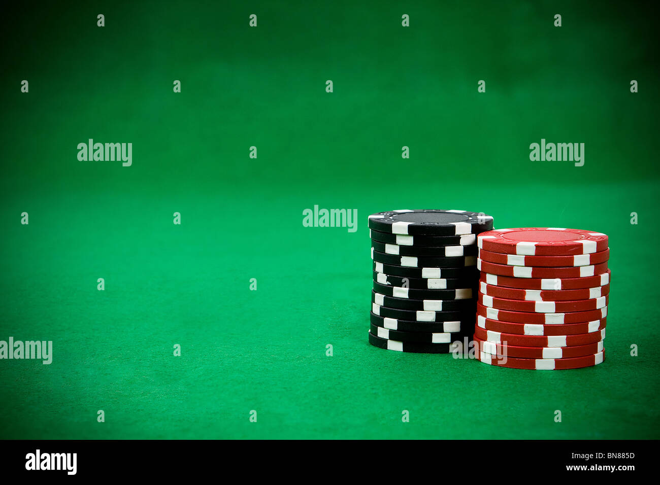 Stack of poker chips on green background Stock Photo - Alamy