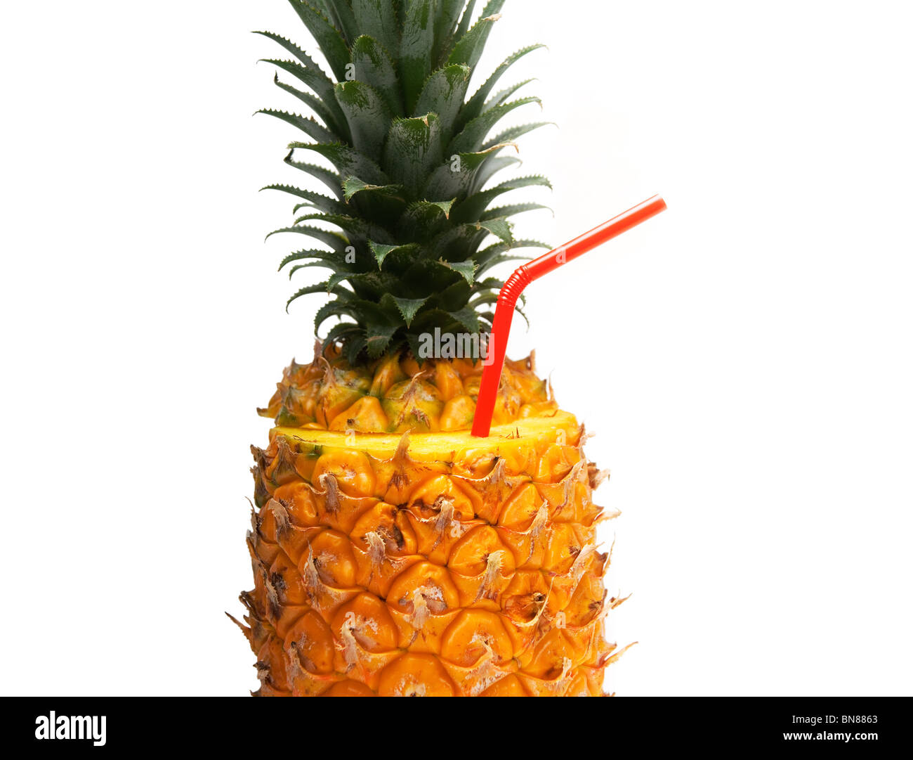 ripe pineapple cutted on top with red and blue straws isolated on white ...