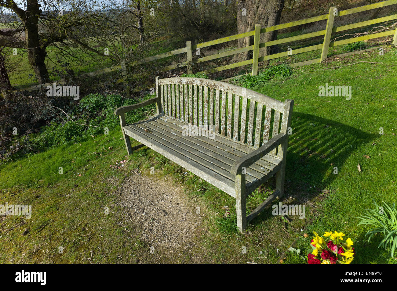 a bench in a country garden Stock Photo - Alamy