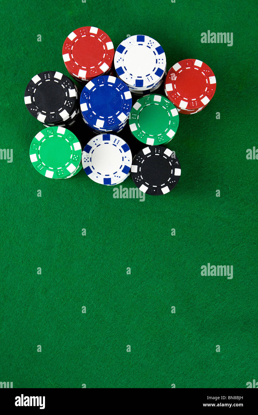 Stack of poker chips over green poker table Stock Photo - Alamy