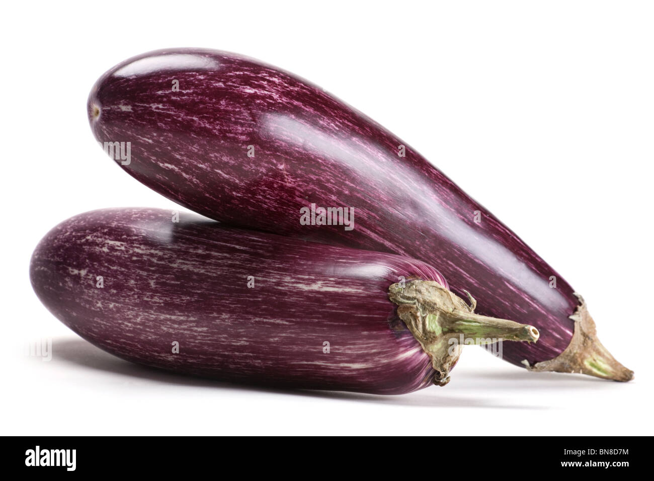 Eggplant purple vegetable closeup with shadow on white Stock Photo - Alamy