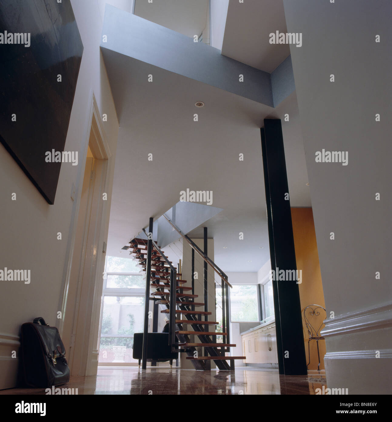 Large white double-height hall with open-tread staircase Stock Photo ...