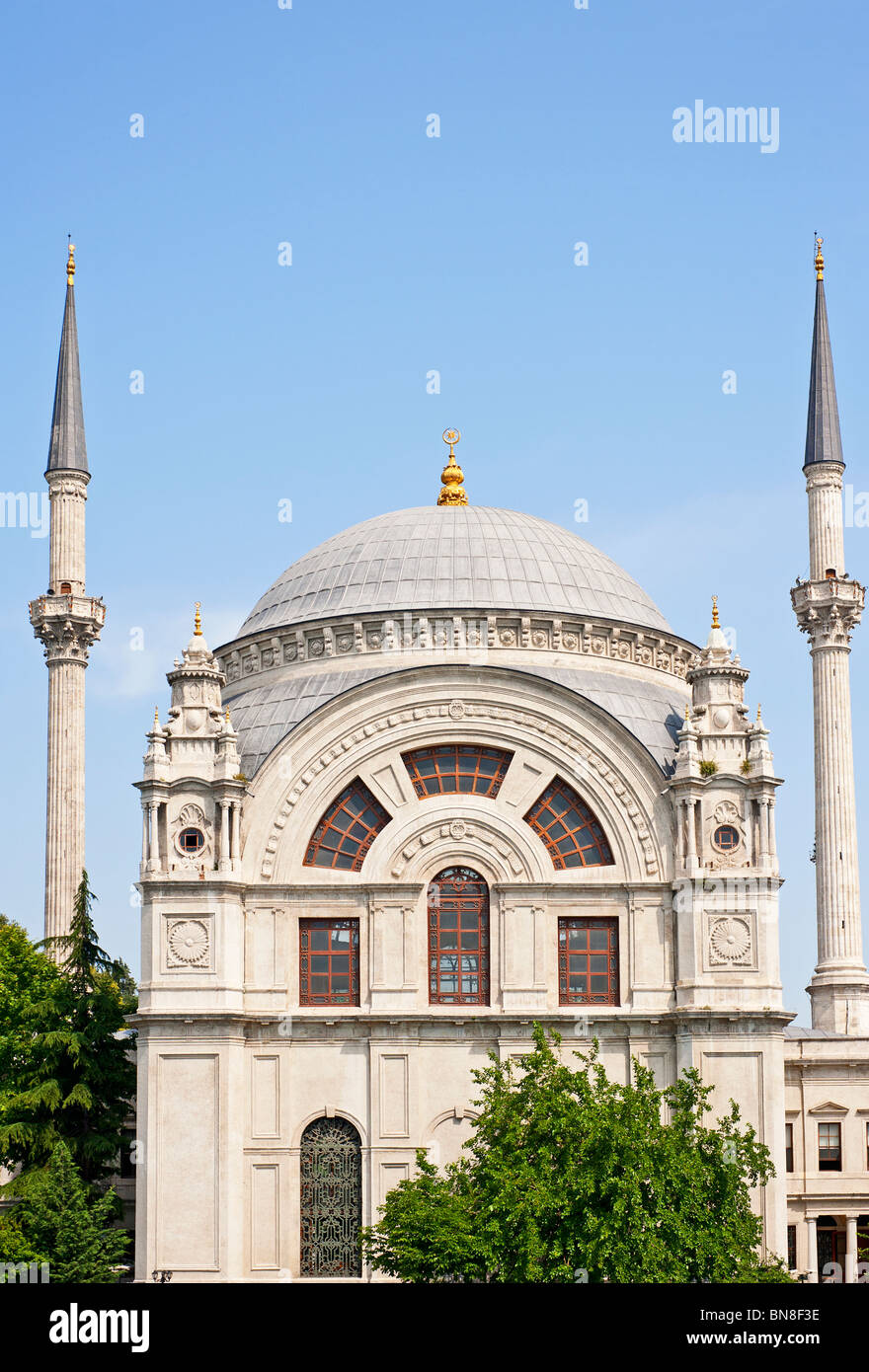A small ornate mosque against a blue sky background Stock Photo - Alamy