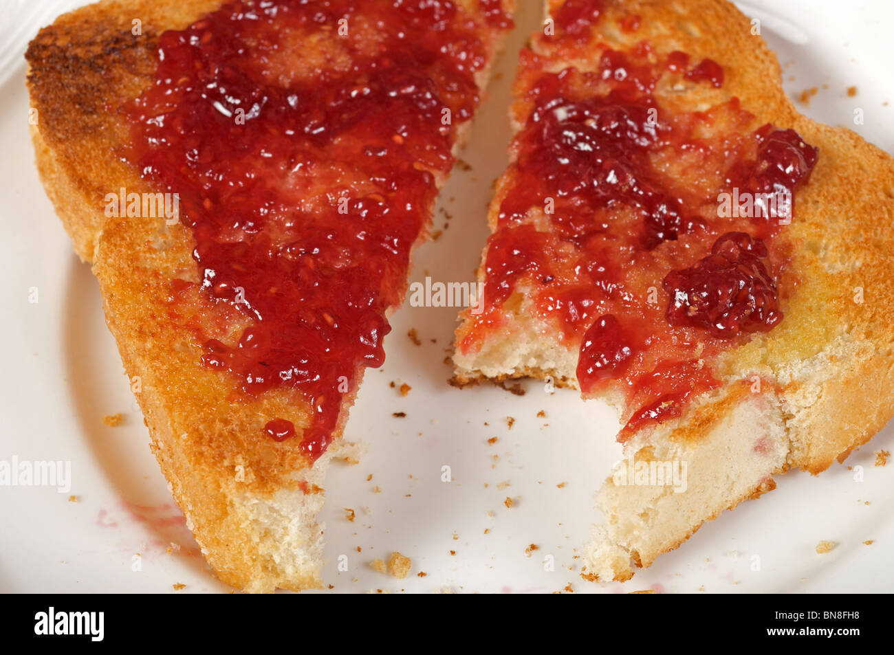 Buttered toast and raspberry jam Stock Photo - Alamy