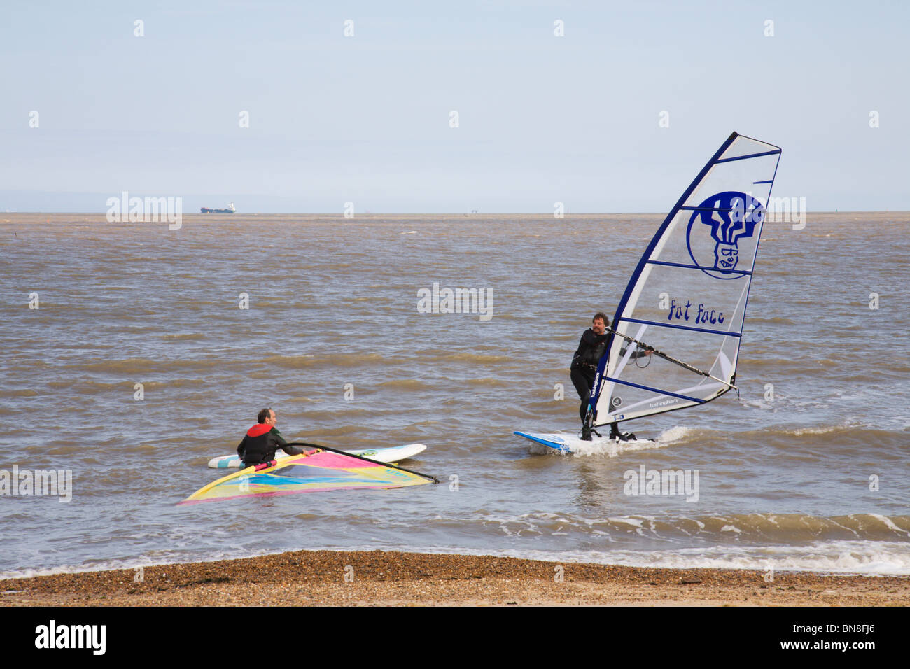 Men sailboarding at Felixstowe beach, Suffolk, England Stock Photo - Alamy