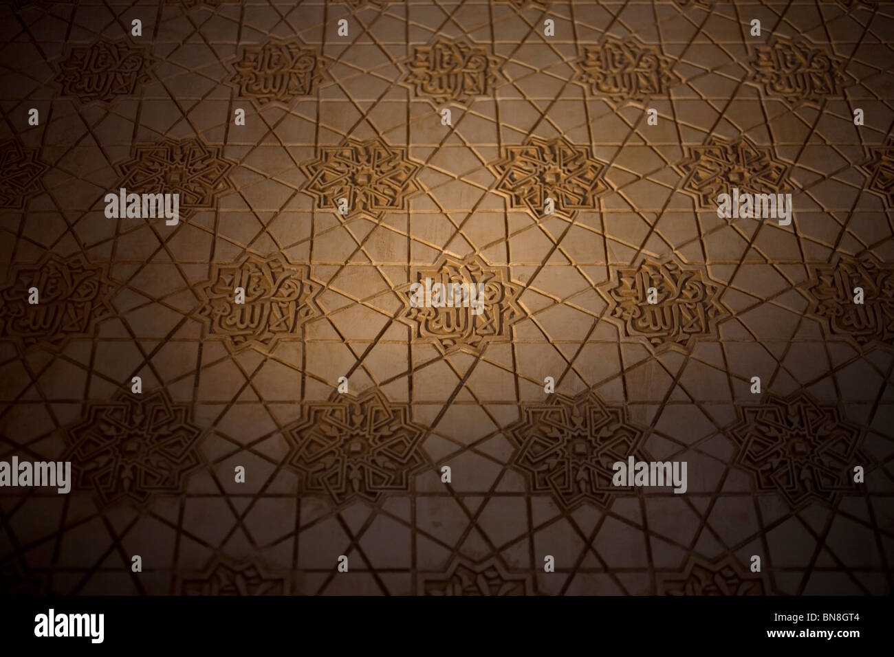 A wall is covered in geometric designs at the Alhambra in Granada ...