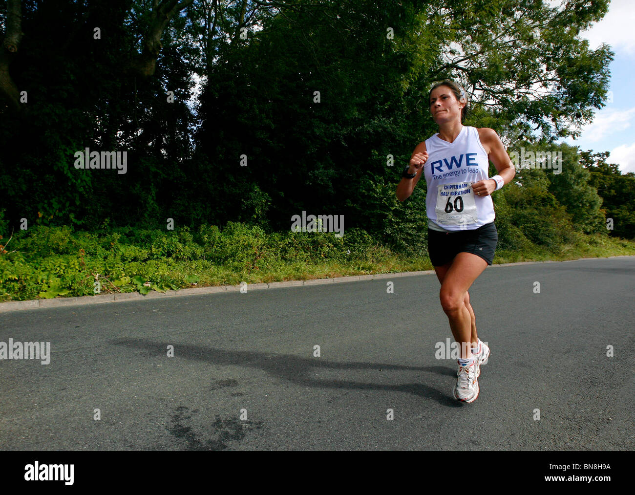 A woman running in a half marathon race in Chippenham Wiltshire England ...