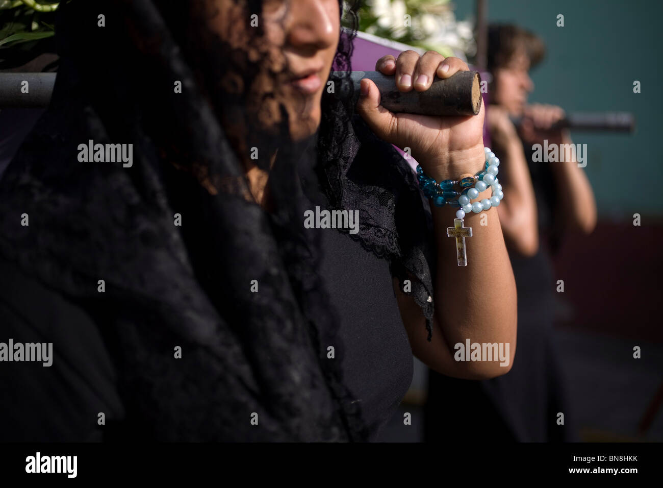 A woman carries a Virgin Mary statue during holy week celebrations in ...