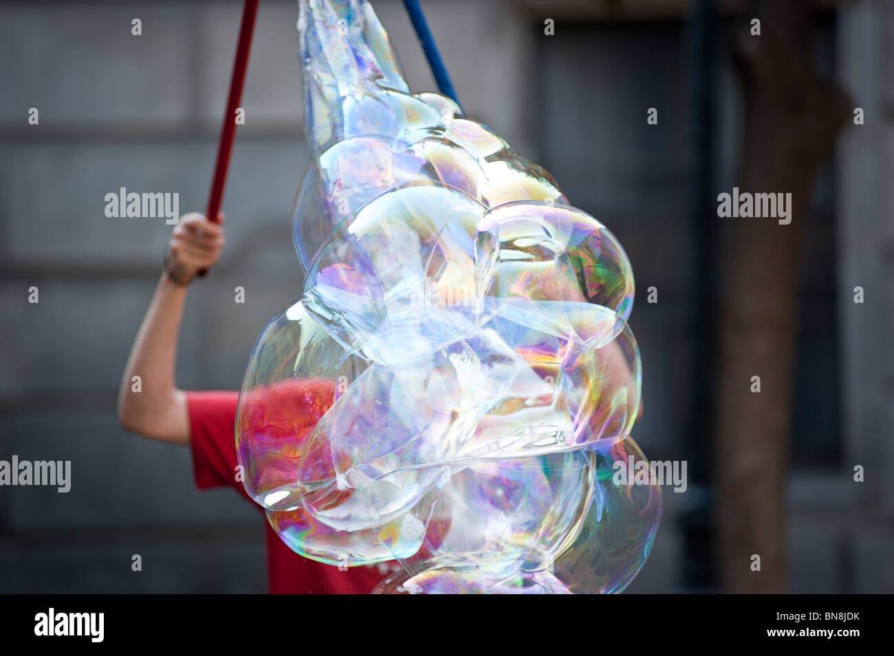 performer blowing giant soap bubbles, Barcelona, Spain Stock Photo - Alamy