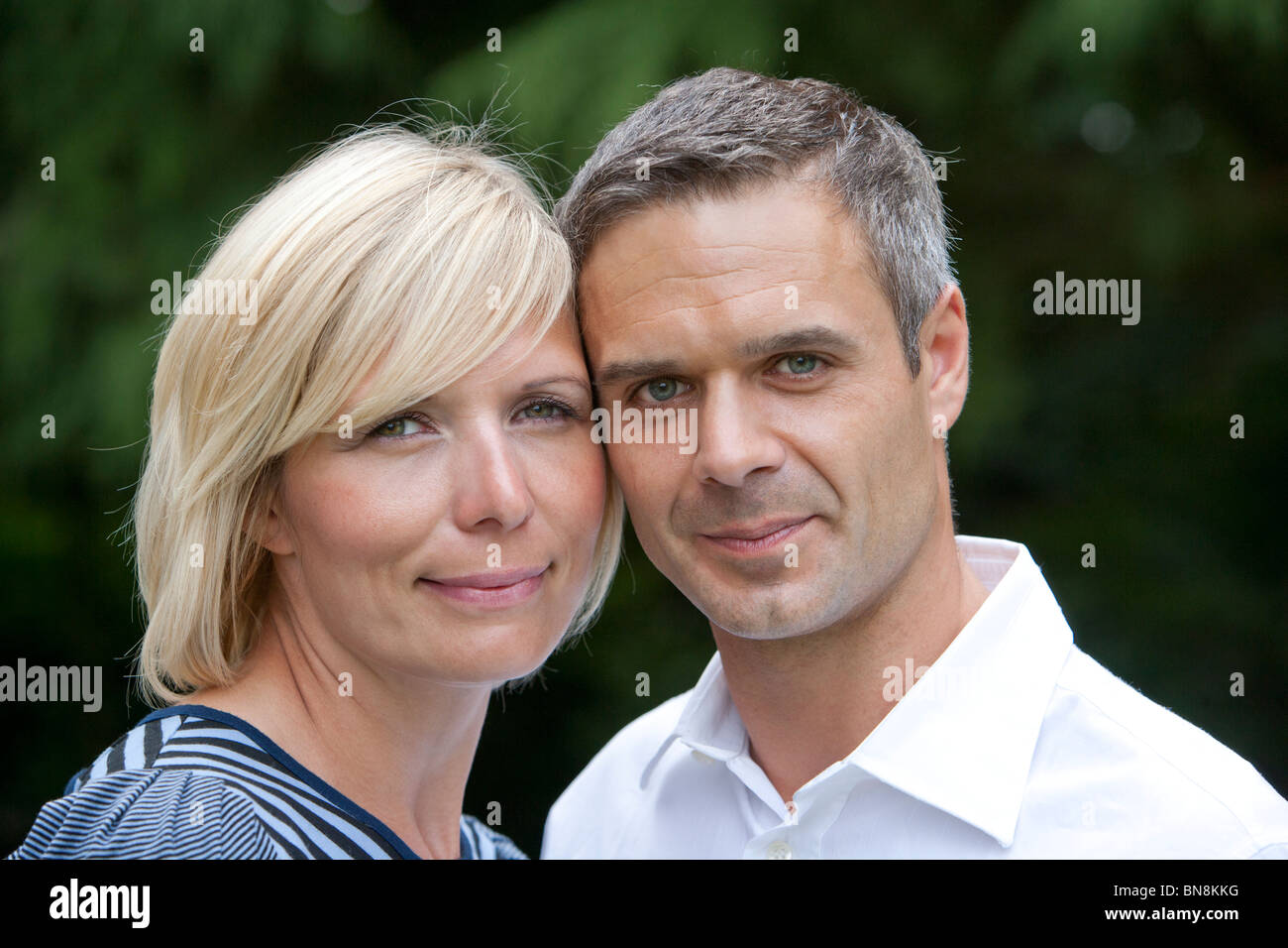 Couple with heads together Stock Photo - Alamy