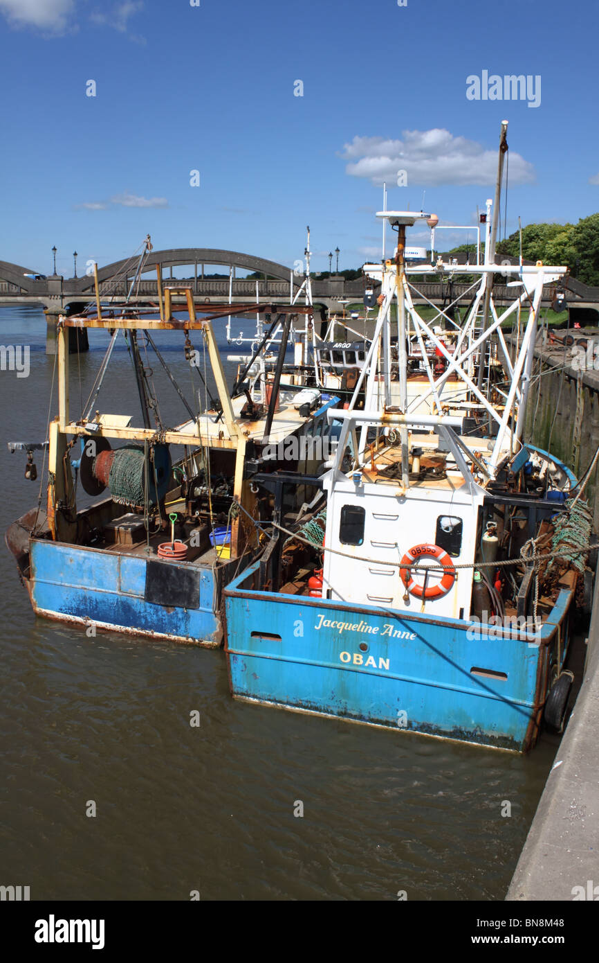 Fishing boats docked in Kirkcudbright harbour, Scotland, with the ...