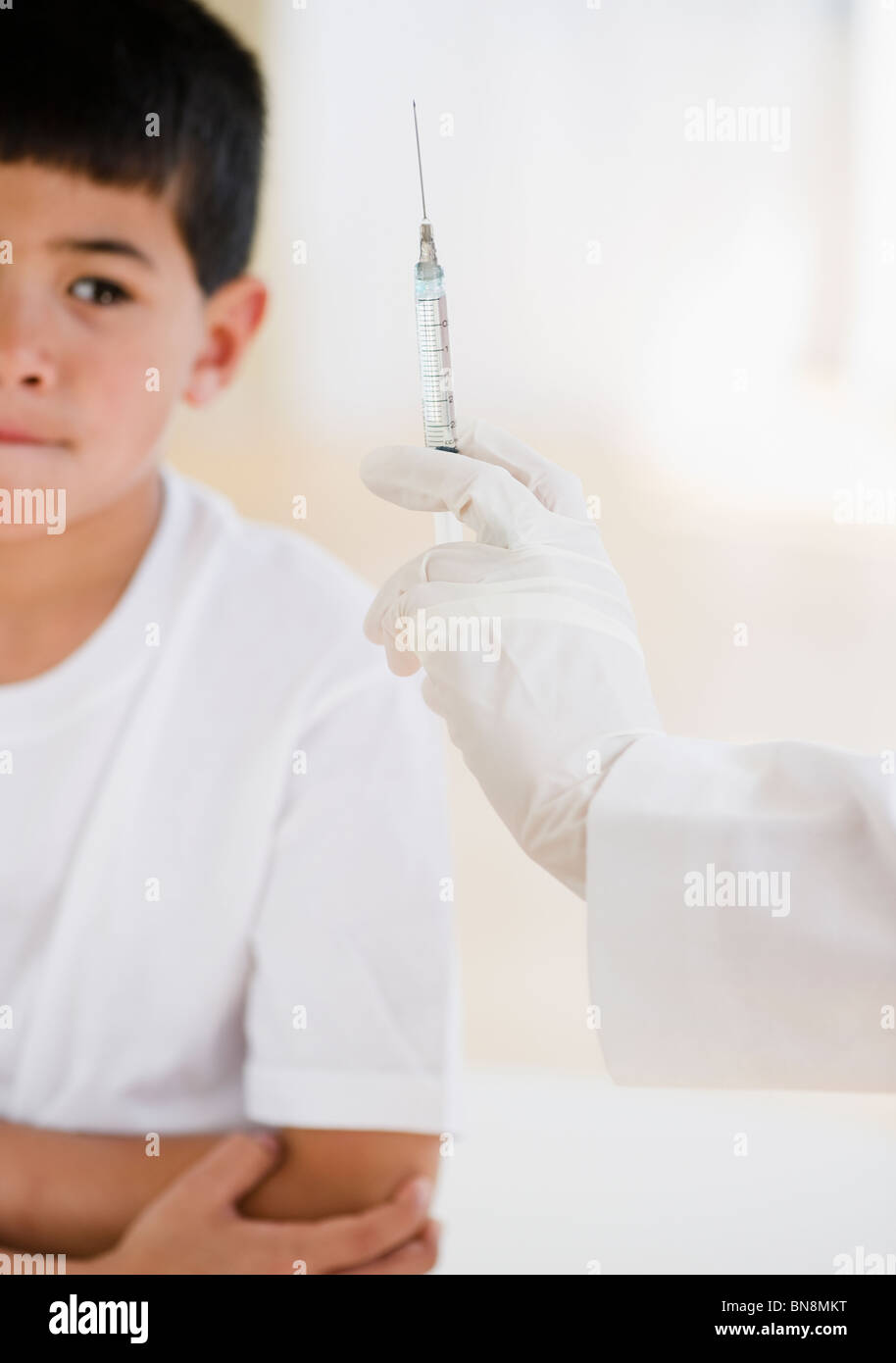 Mixed race boy worrying about injection Stock Photo - Alamy