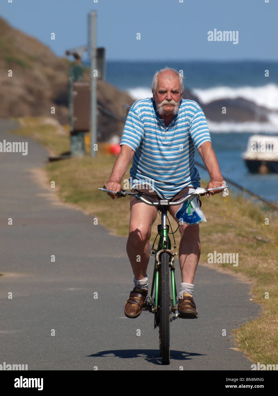 Old man riding a bicycle, Bude, Cornwall, UK Stock Photo - Alamy