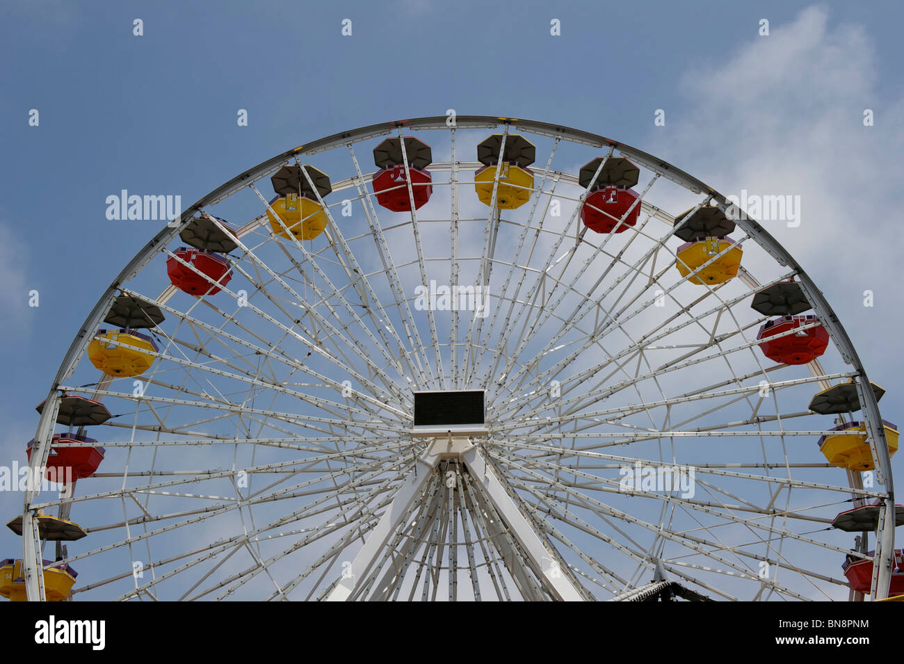 Side view of Ferris Wheel with Red and Yellow Gondolas on Santa Monica ...