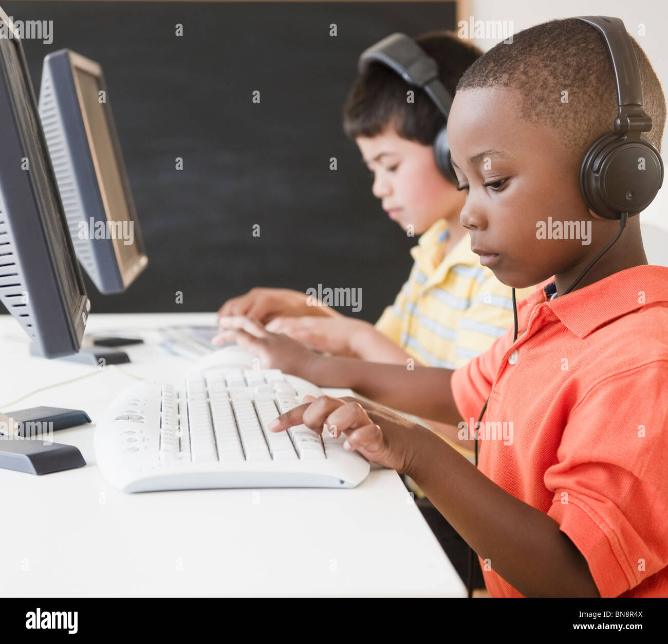 Boys typing on computers in computer lab Stock Photo - Alamy