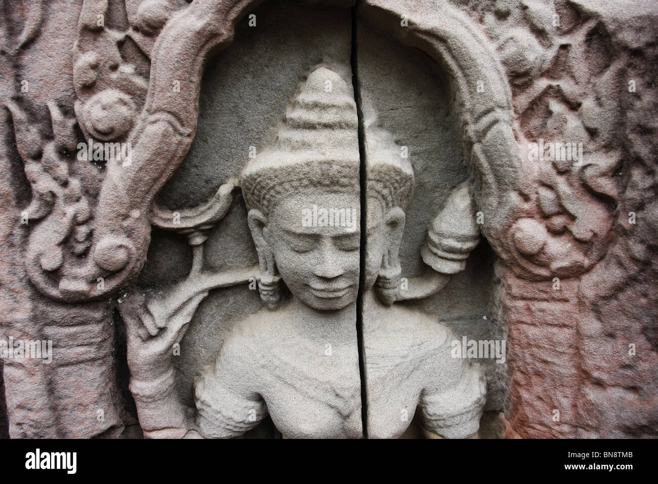 The sculpture of a devata, a female deity, in a temple wall at Preah ...