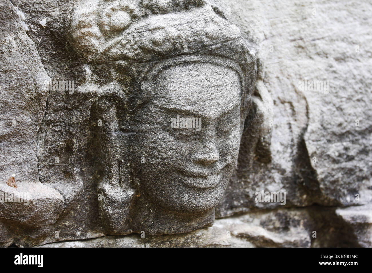 The sculpture of a devata, a female deity, in a temple wall at Preah ...