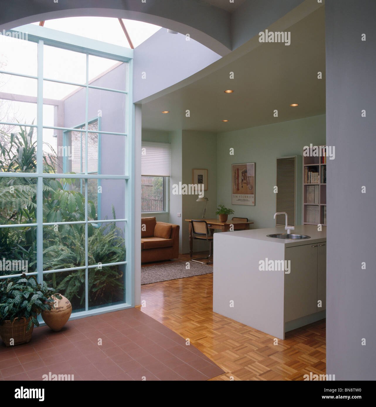 Atrium in open-plan modern living room and kitchen Stock Photo - Alamy