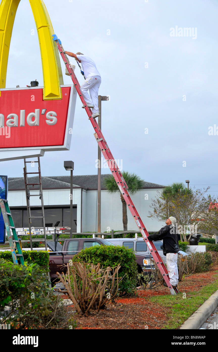 Restoration painting repair on commercial sign Stock Photo - Alamy