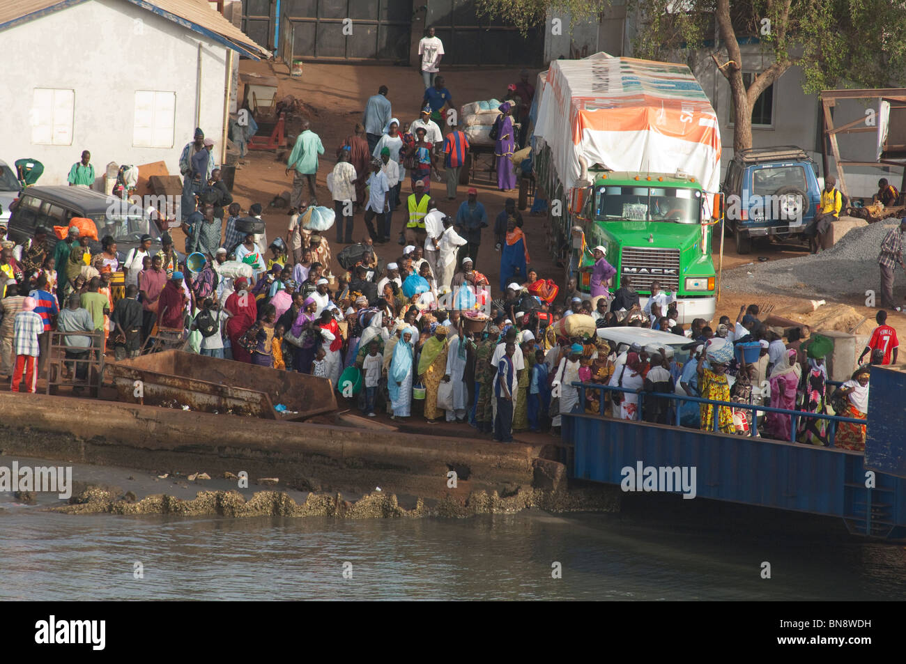 Africa, Gambia. Capital city of Banjul. Port area of Banjul. Crowds of ...
