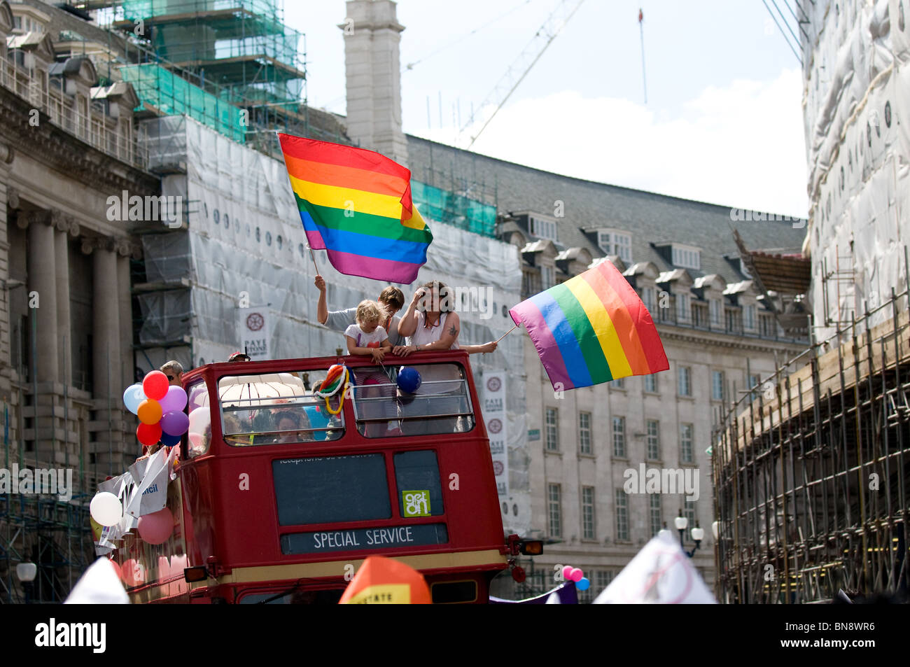 People on an open topped bus participating in the Pride London ...