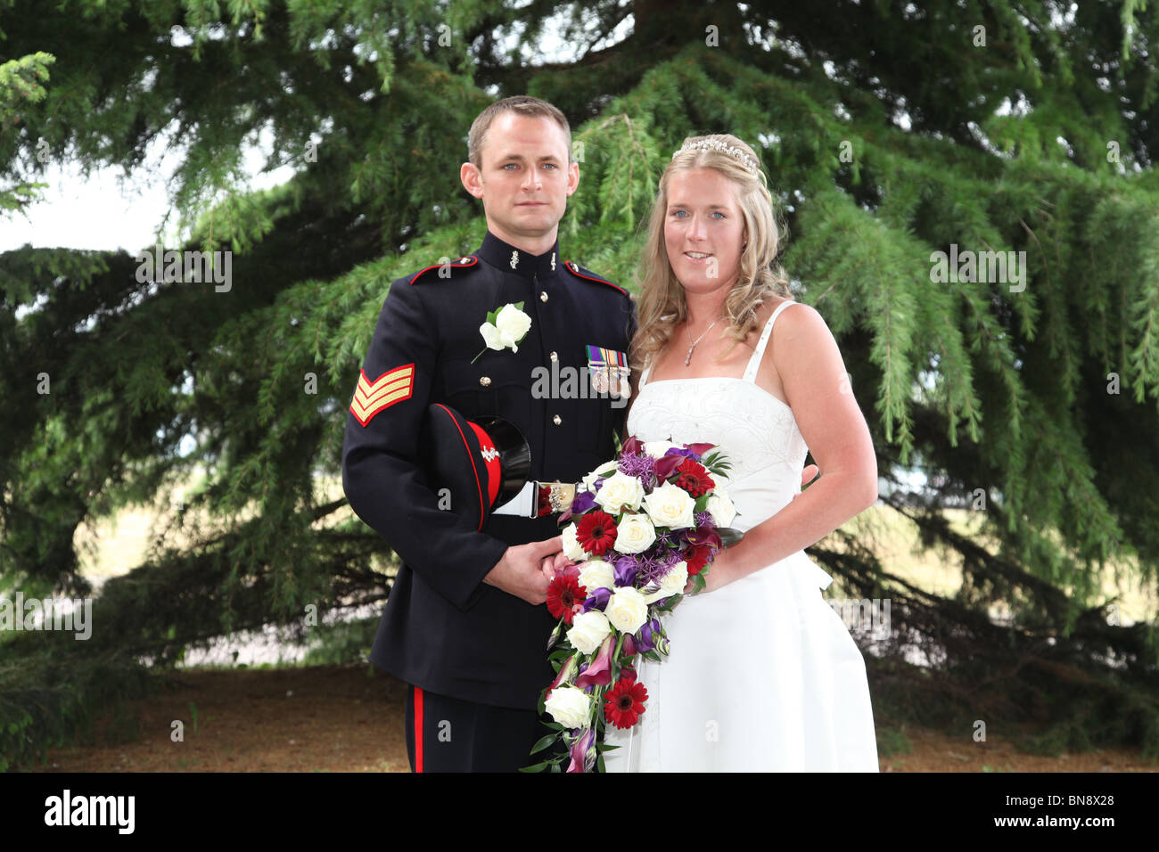 British Army Sergeant marries his bride; bride and groom posing after ...