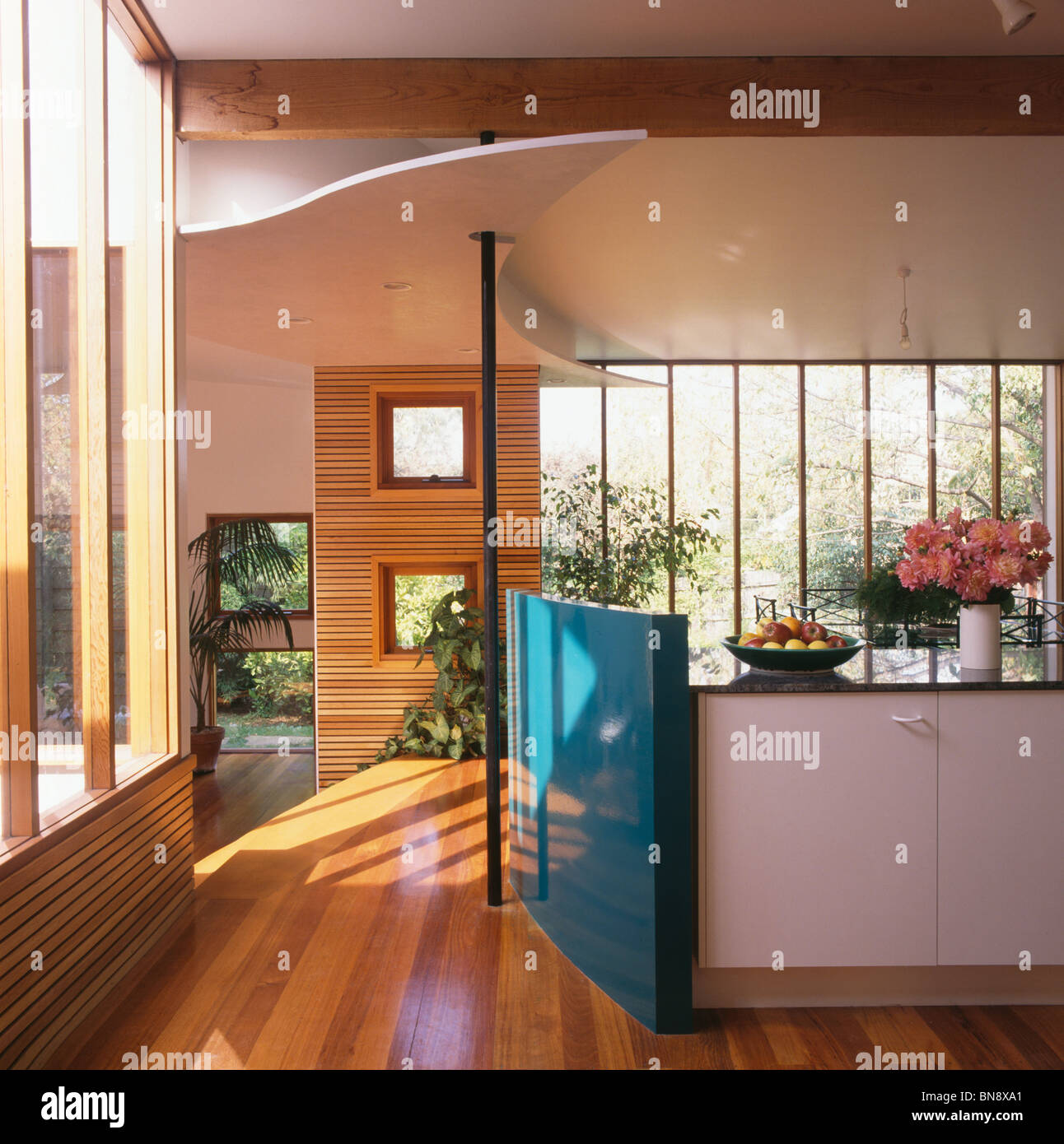 Turquoise panel in open-plan modern hall with integral kitchen and ...