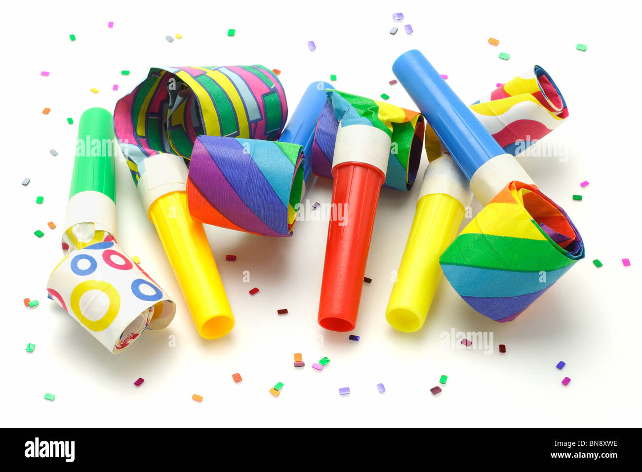 Multicolor party blowers on white background Stock Photo - Alamy