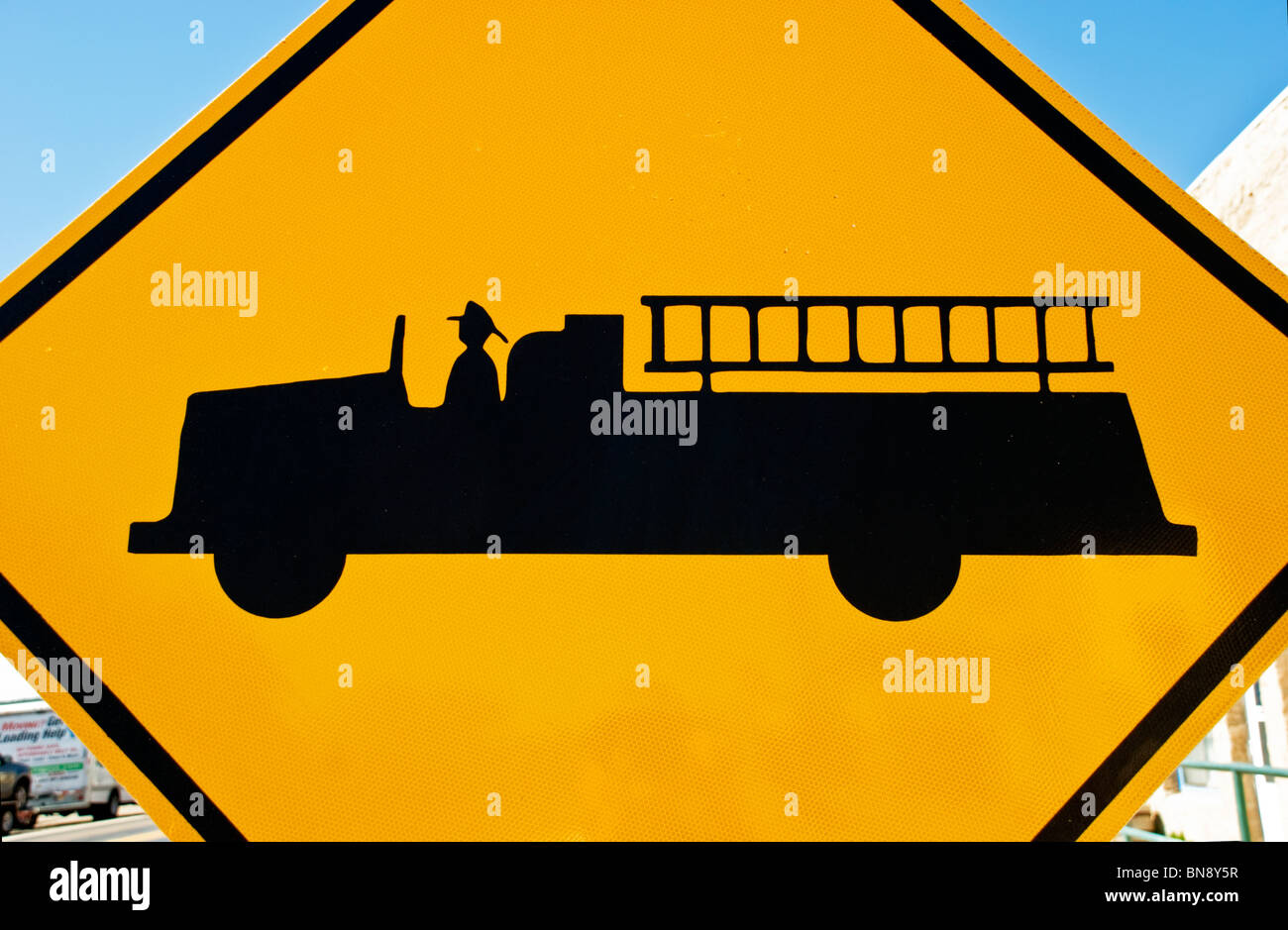 A bright sign signifying a fire truck glows against the pretty blue New ...