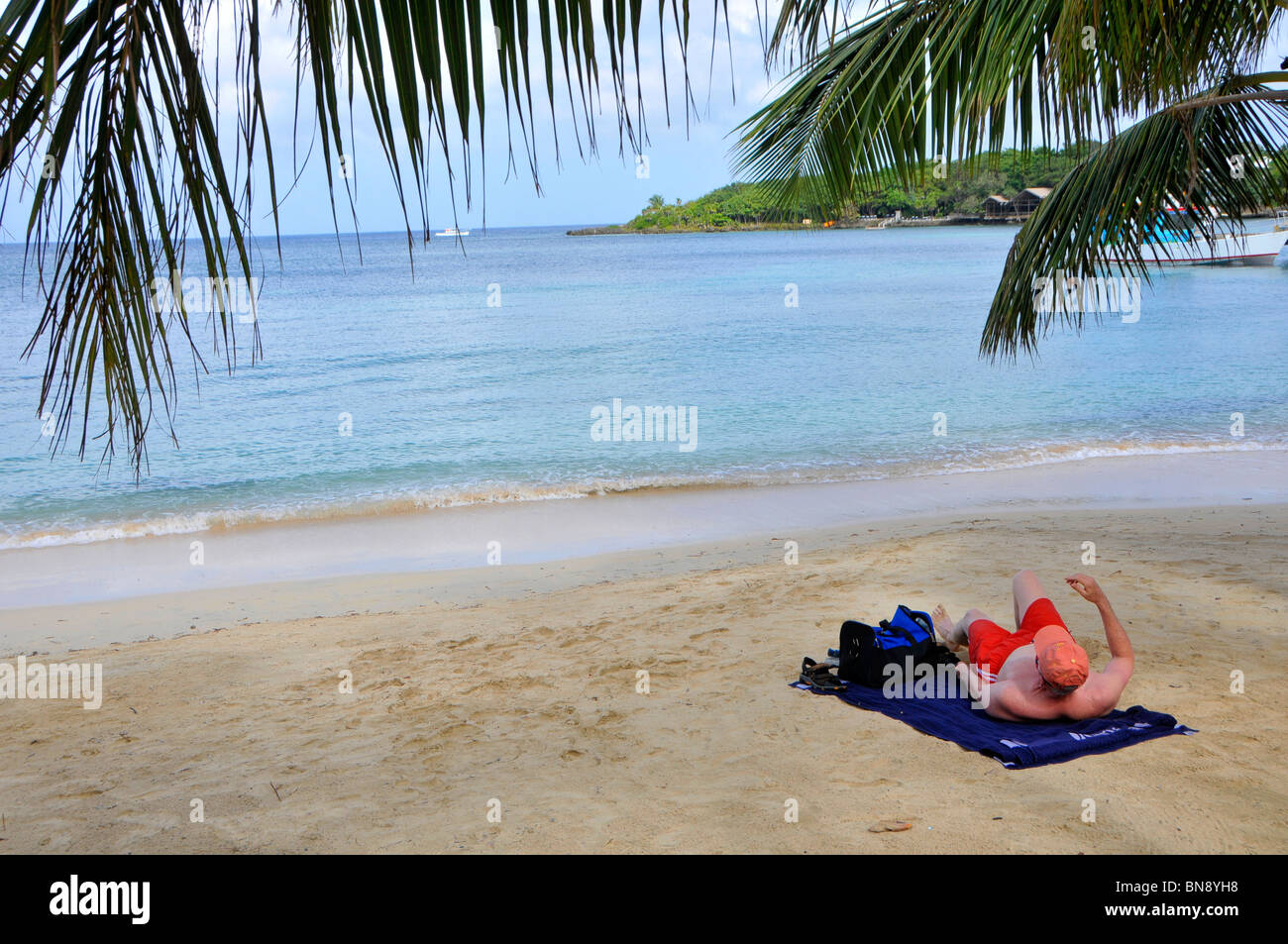 Tourist enjoys sandy beach Isla Roatan Honduras Central America Stock ...