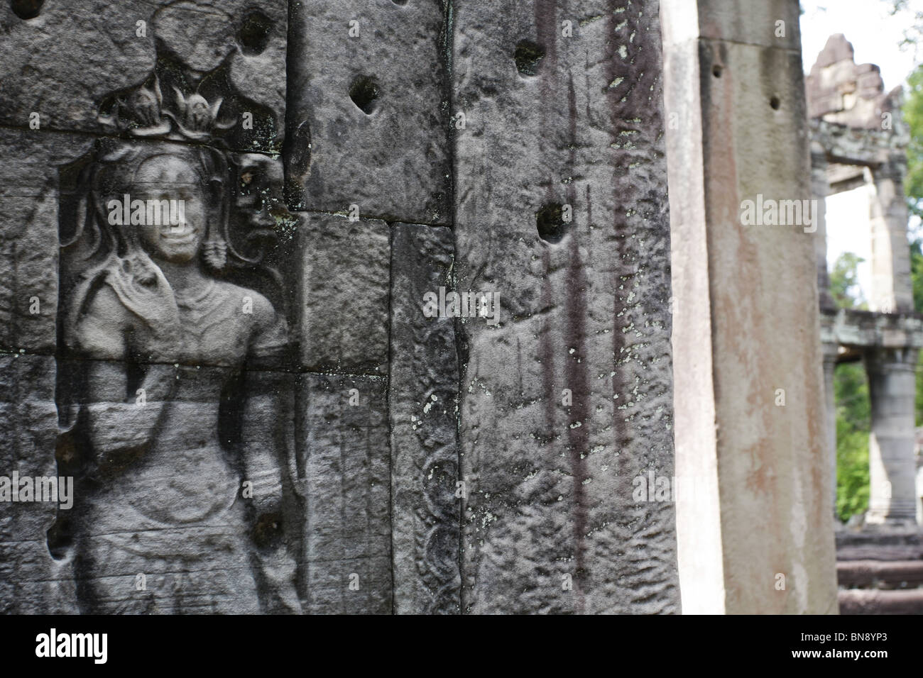 The sculpture of a devata, a female deity, in a temple wall at Preah ...
