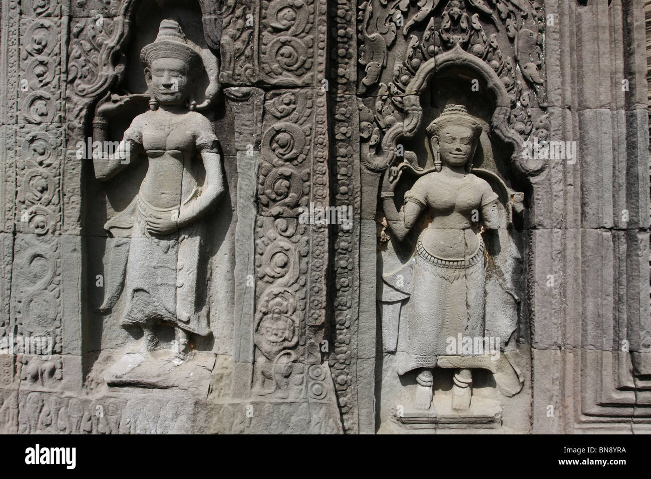 The sculptures of devatas, female deities in a temple wall at Preah ...