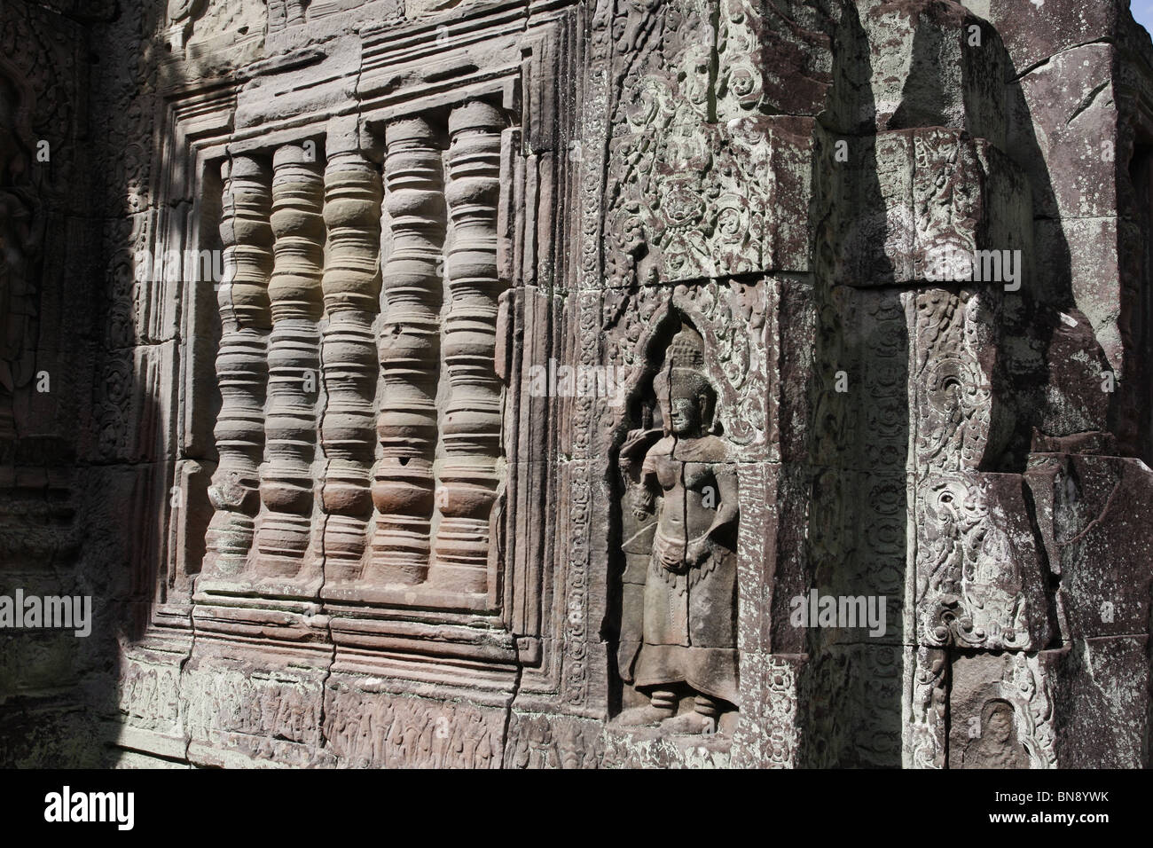 The sculpture of a devata, a female deity, in a temple wall at Preah ...