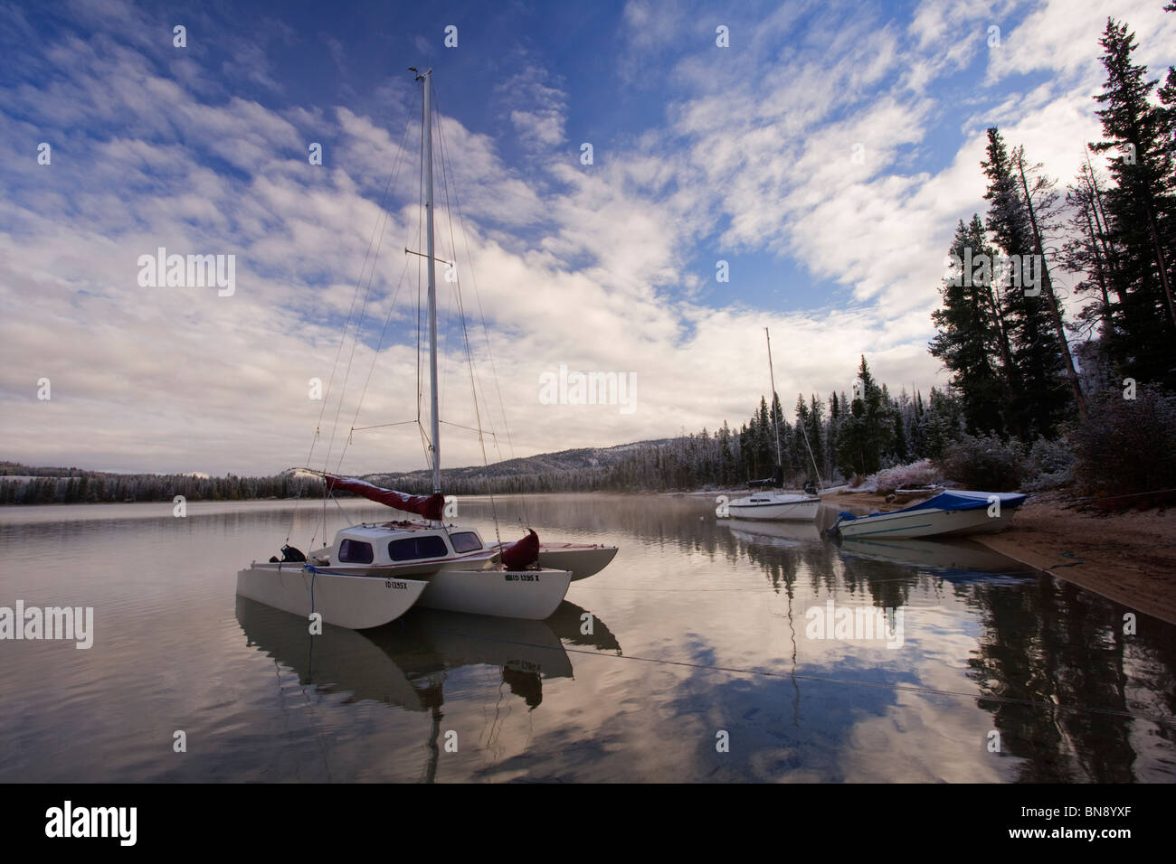 Boat in the dock on the Red fish lake with the Sawtooth mountains in ...