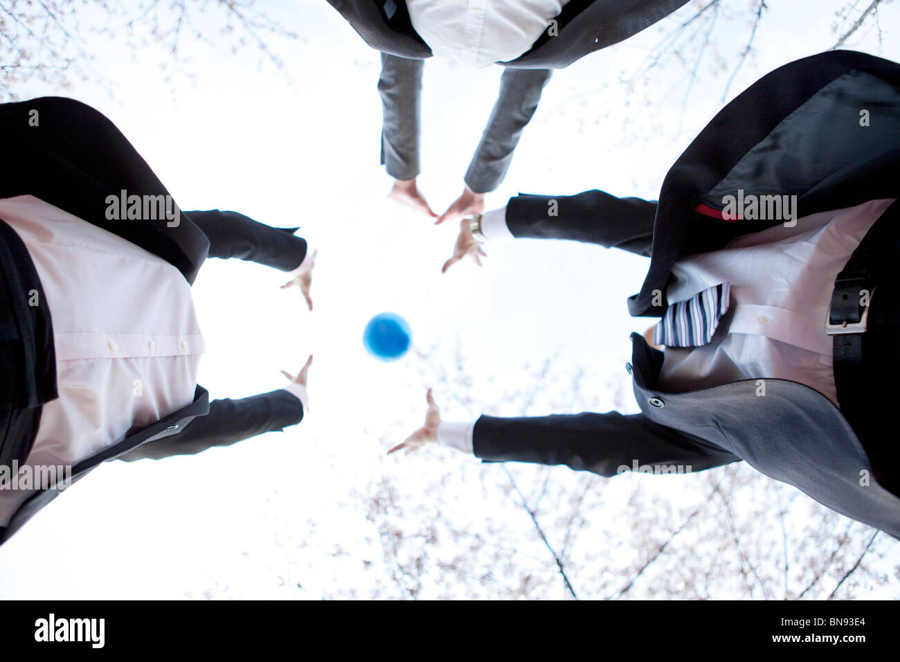 Business people reaching for a ball in the air Low angle view Stock ...