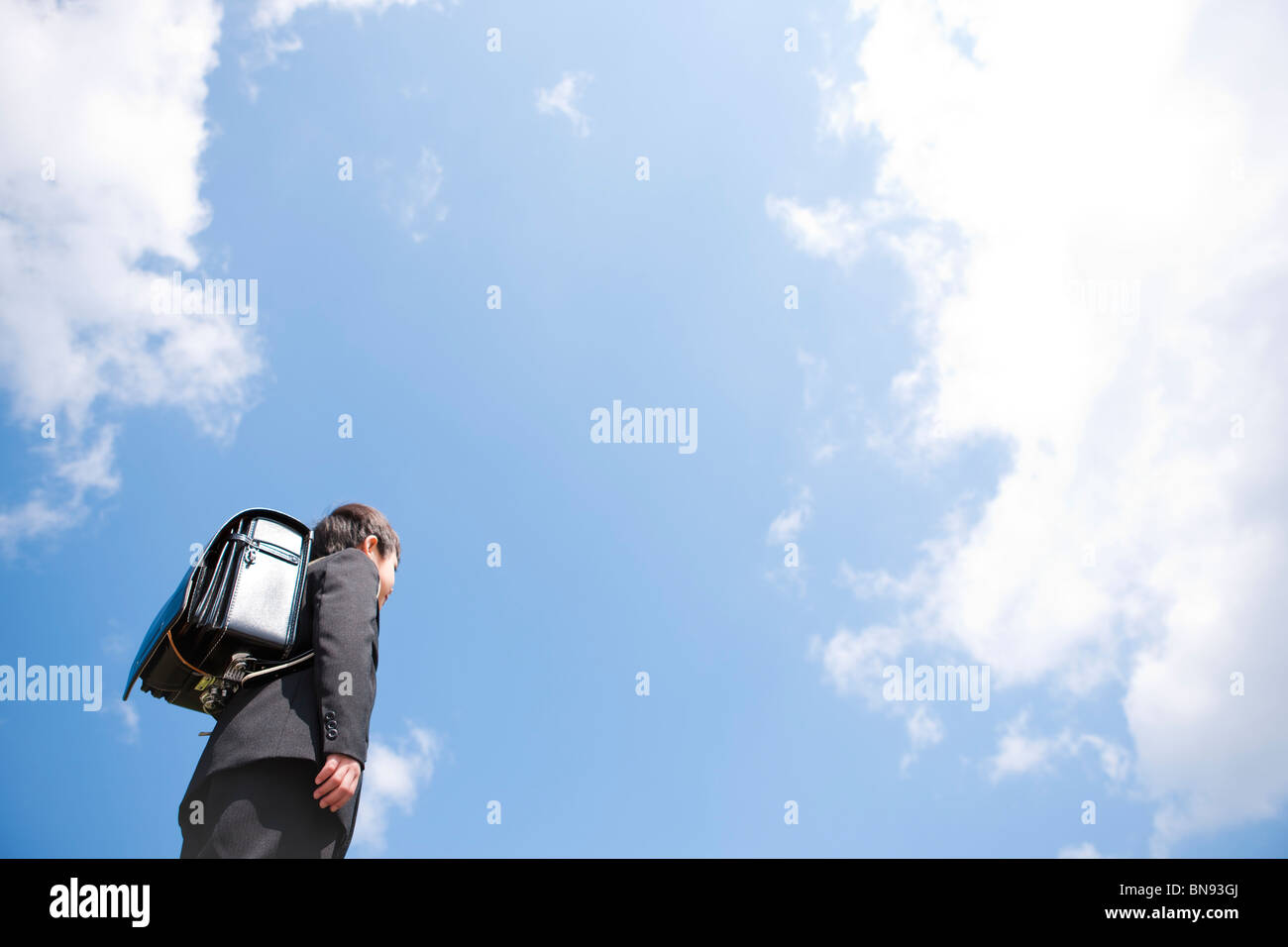 Elementary school boy standing Stock Photo - Alamy
