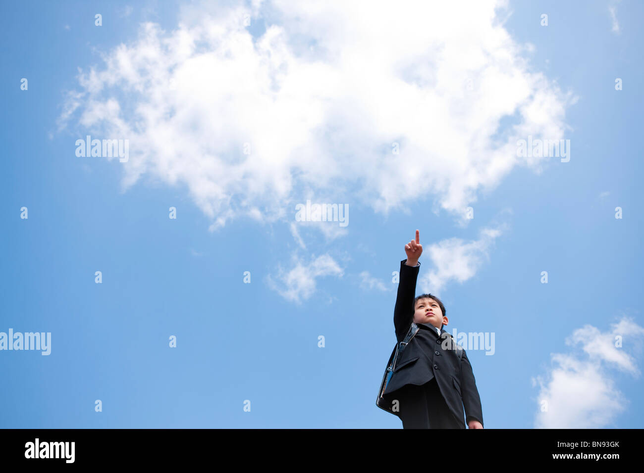 Elementary school boy standing and pointing Stock Photo - Alamy
