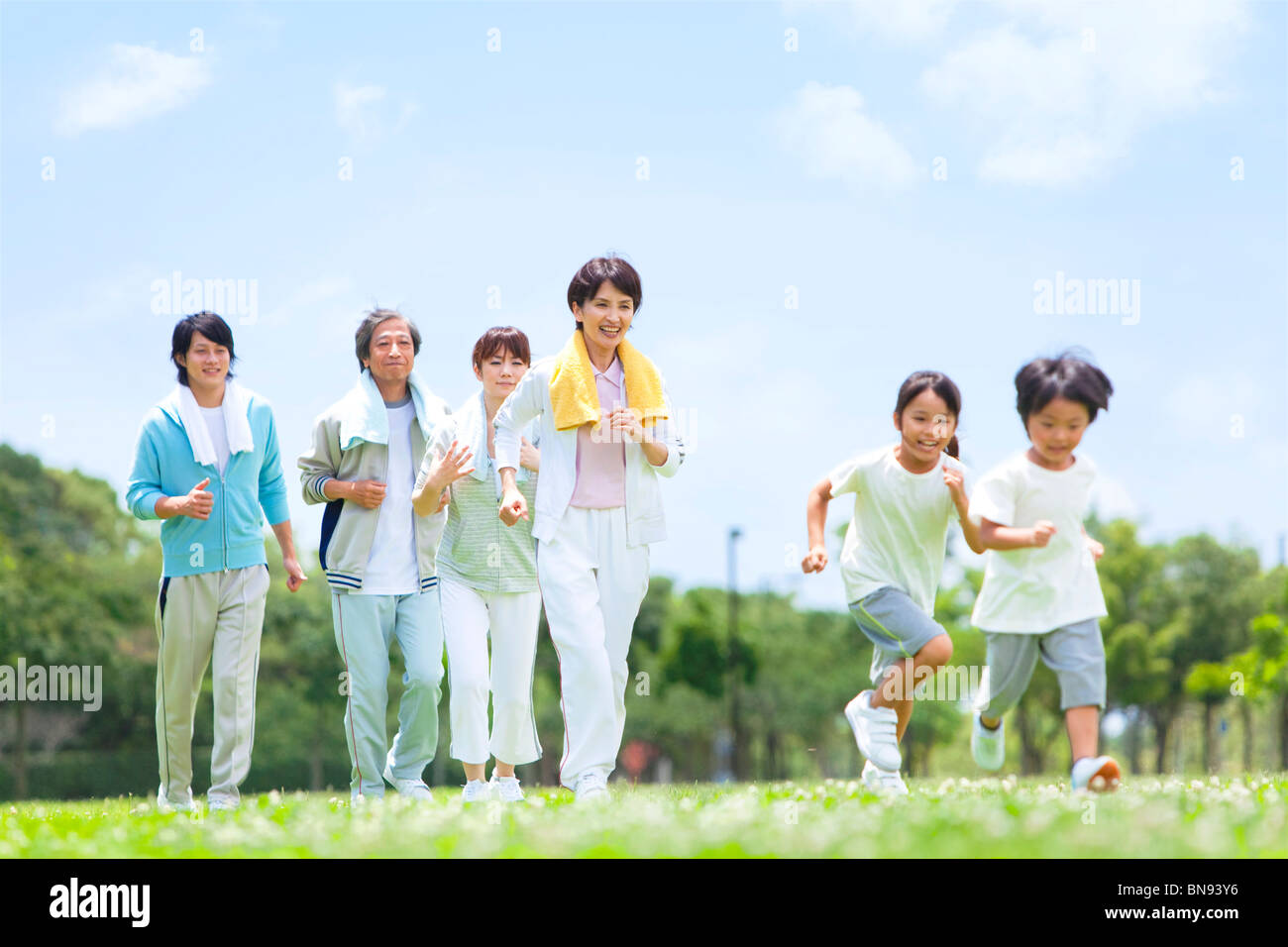 Three generation of family jogging Stock Photo - Alamy