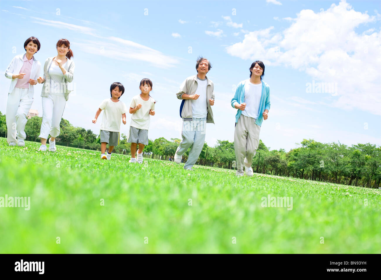 Three generation of family jogging Stock Photo - Alamy