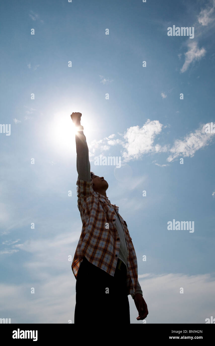 Young Man Punching the Air Under Blue Sky Stock Photo - Alamy